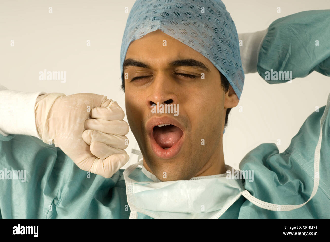 Tired surgeon stretching and yawning Stock Photo - Alamy