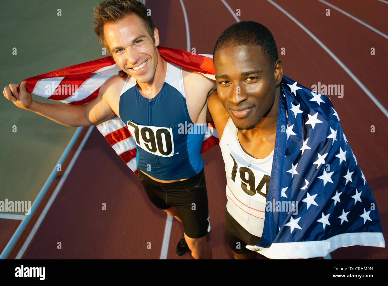 Running teammates holding up American flag after race Stock Photo - Alamy