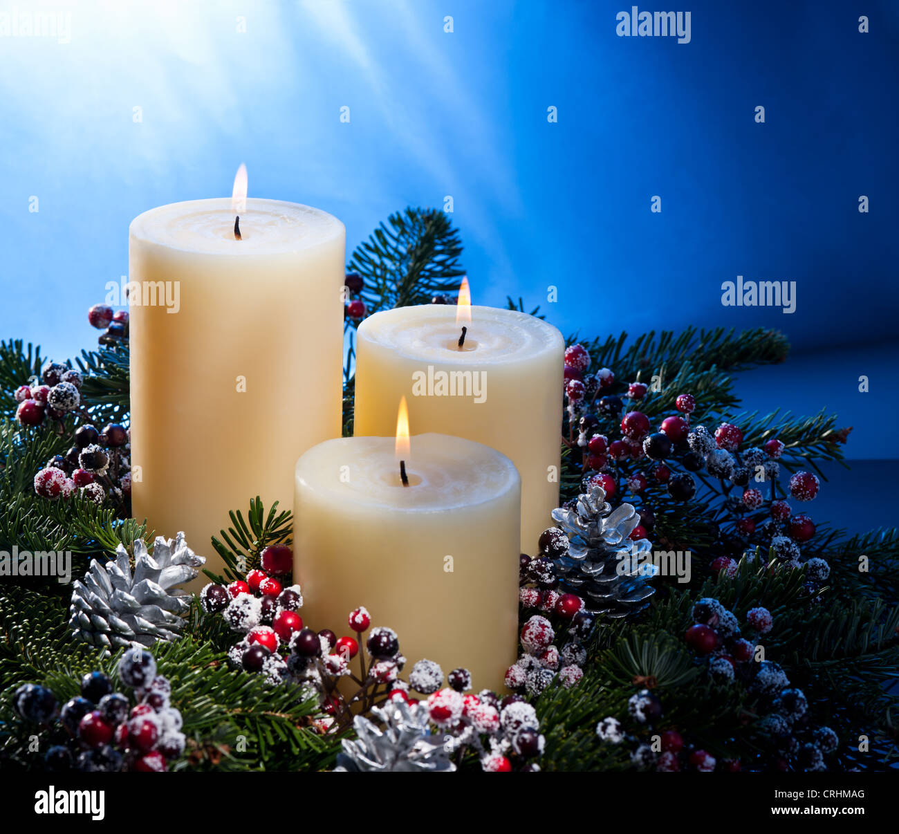 Three candles in an advent flower arrangement for advent and Christmas ...