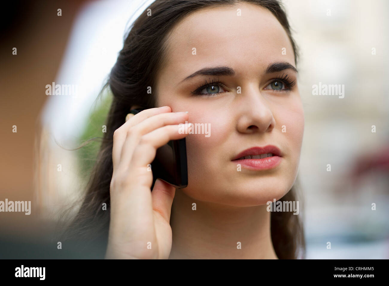 Young woman using cell phone Stock Photo - Alamy