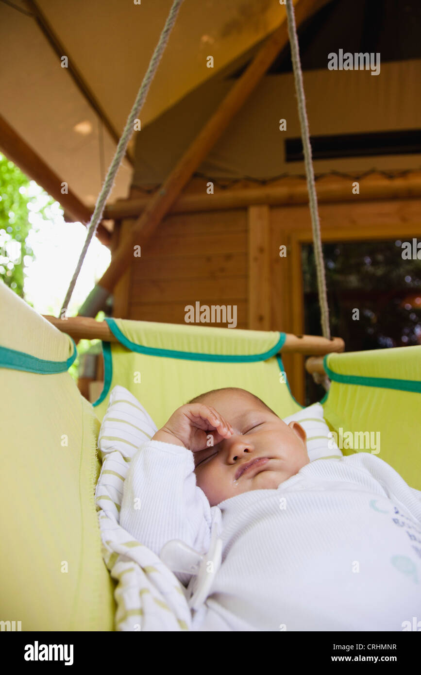 Baby napping in cradle outdoors Stock Photo - Alamy