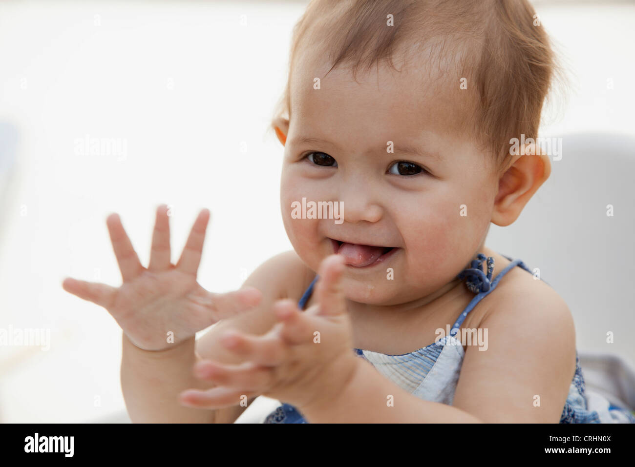 Baby girl clapping her hands and smiling Stock Photo - Alamy