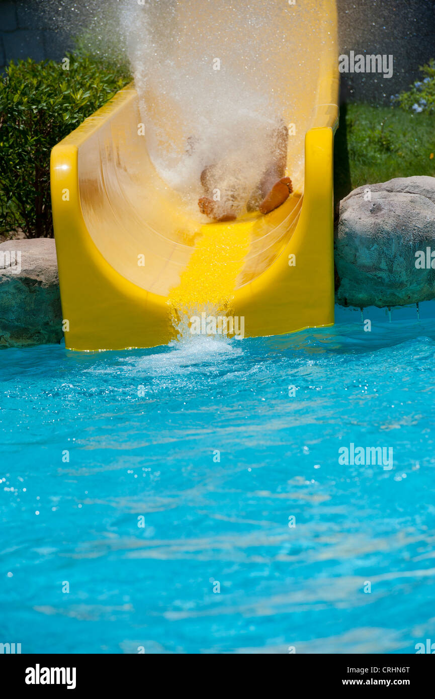 Person having fun in the summer coming down a long water chute Stock ...