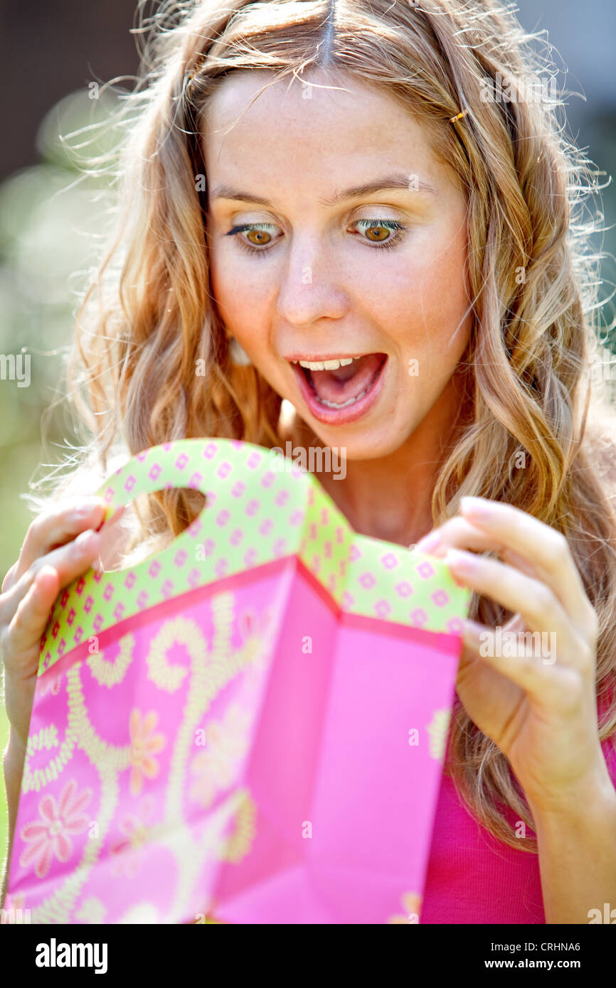 Surprised young woman opening gifts hi-res stock photography and images ...