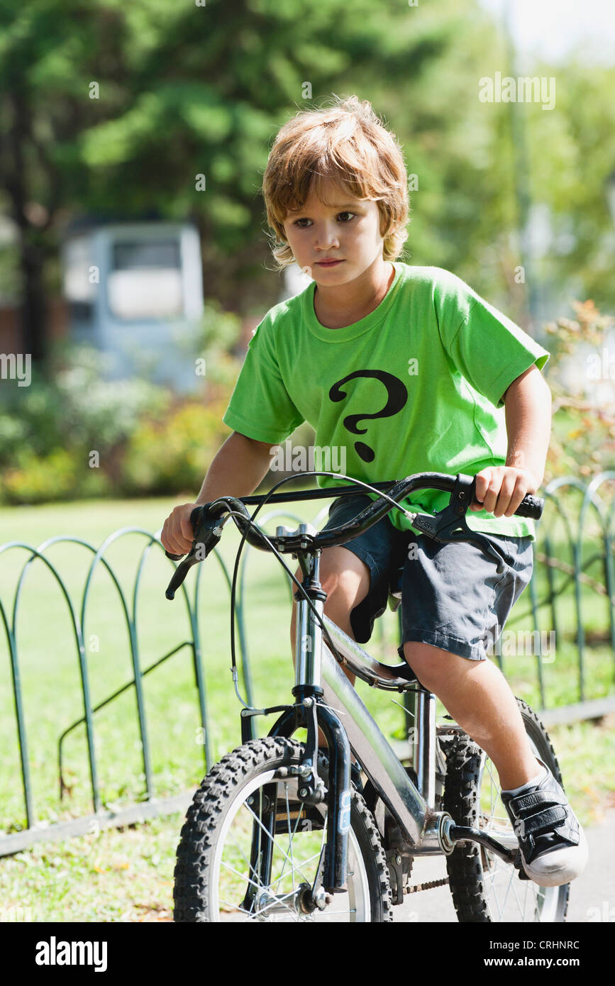 Boy riding bicycle Stock Photo - Alamy