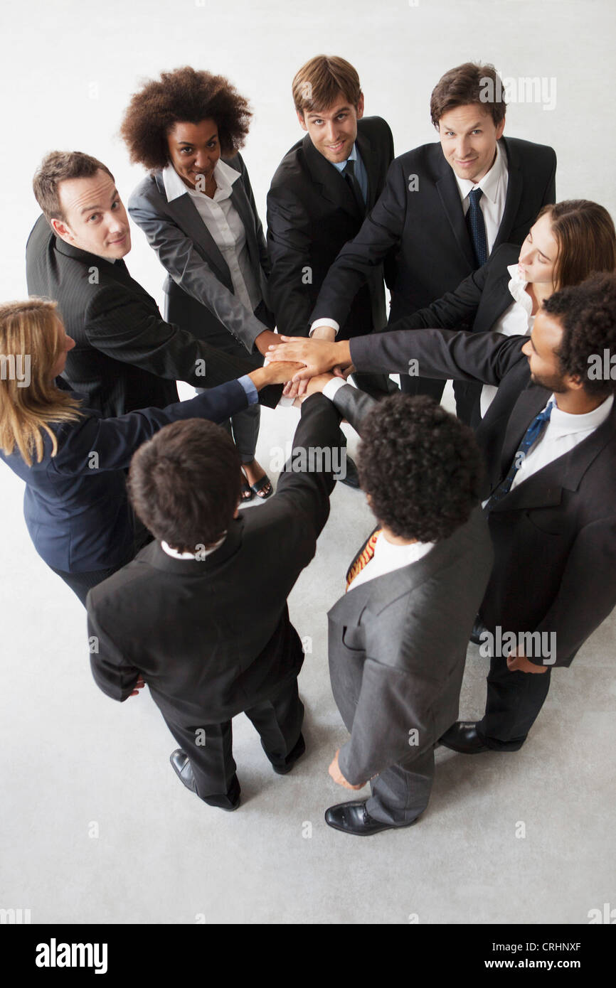Business team members link hands in solidarity Stock Photo - Alamy