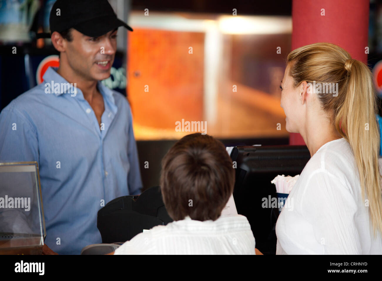 Mother and son ordering food at counter, rear view Stock Photo - Alamy