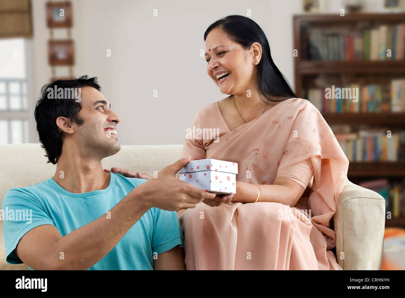Son giving gift to his mother Stock Photo - Alamy