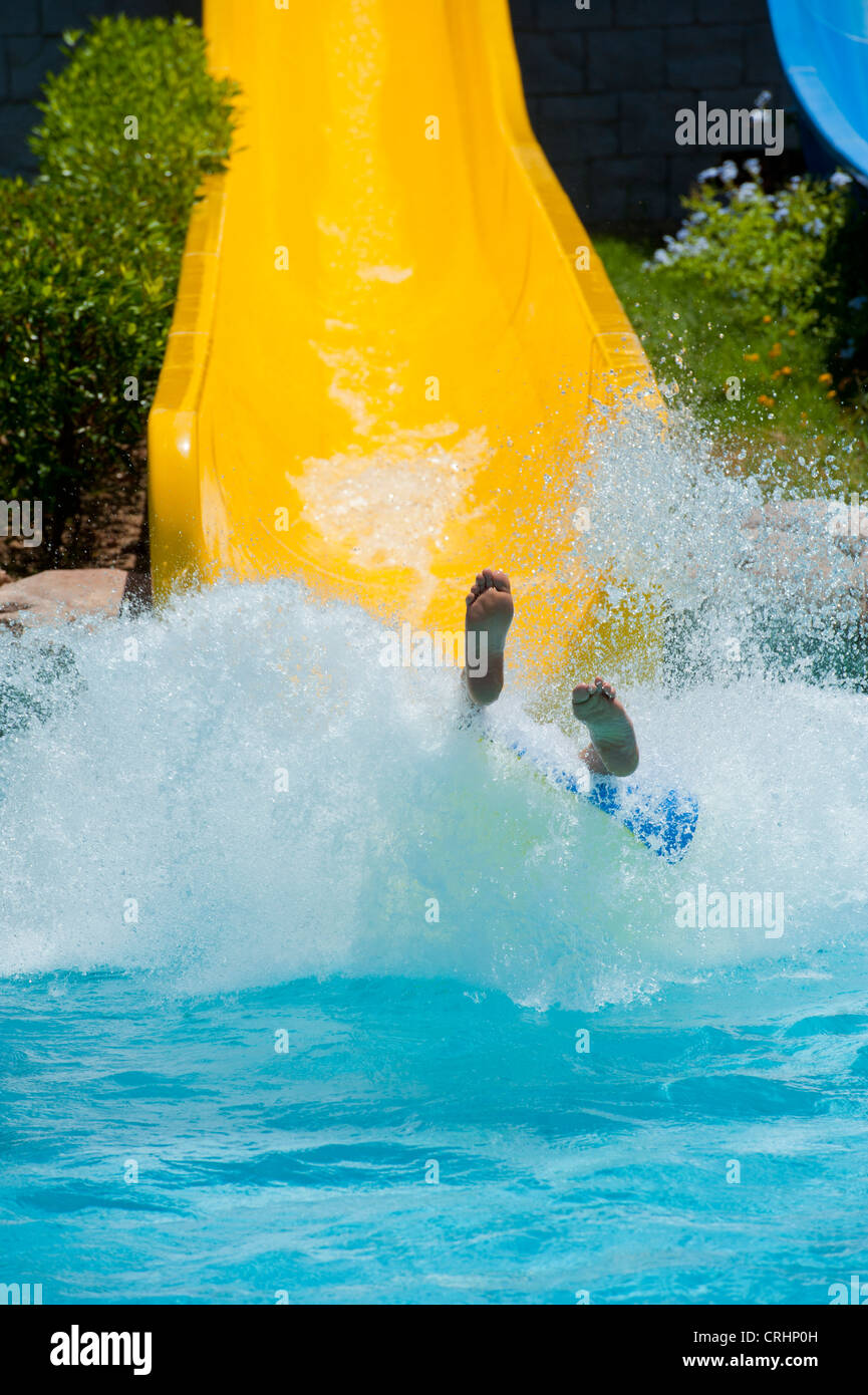 Person having fun in the summer coming down a long water chute Stock ...