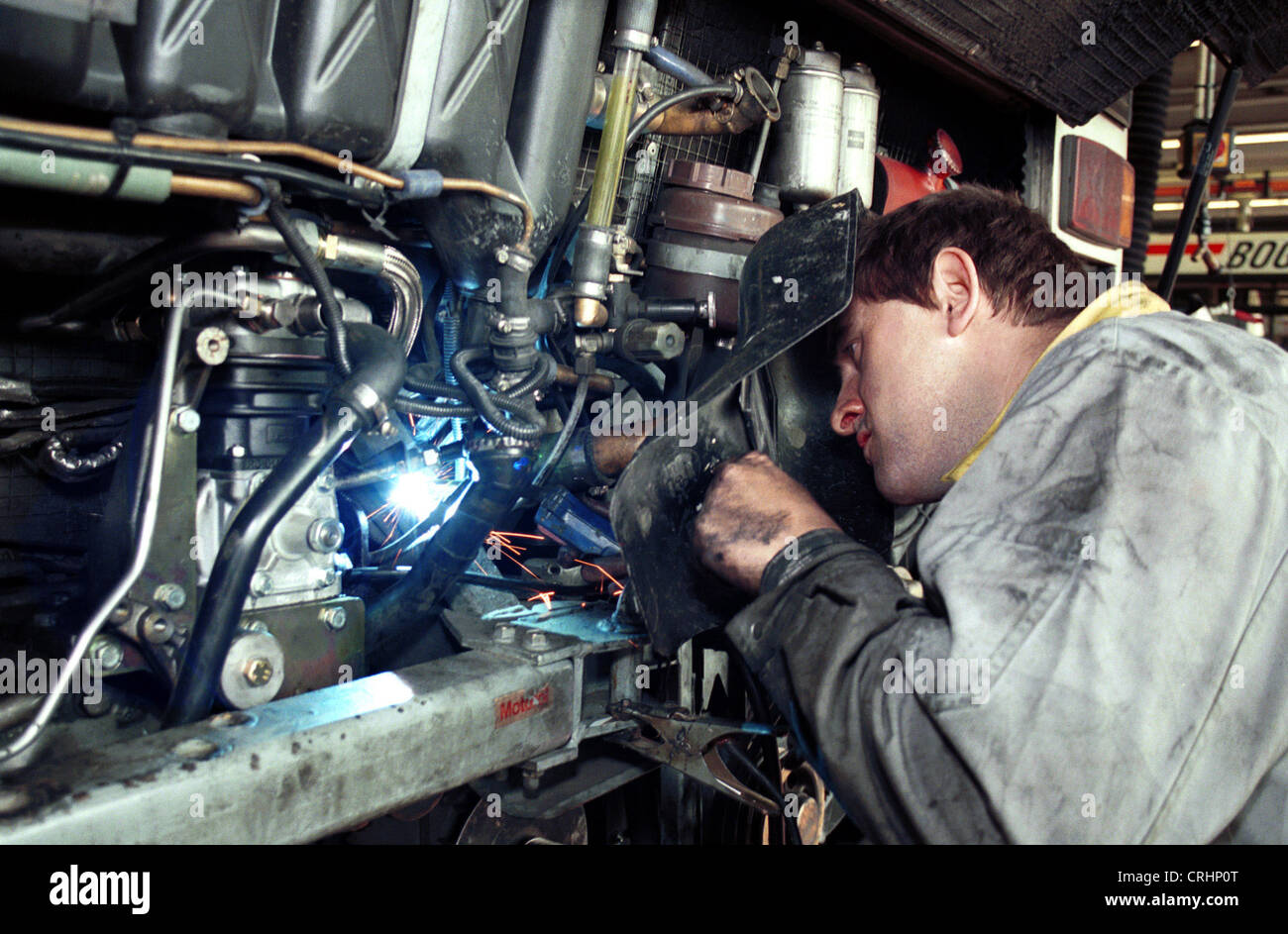 Bochum, Germany, car mechanic repairs engine Stock Photo - Alamy