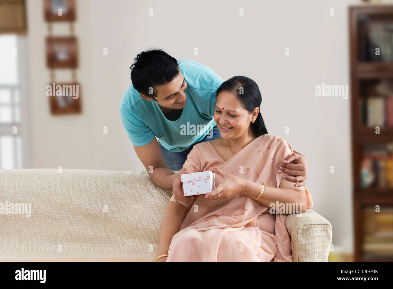 Young man giving gift to his smiling mother Stock Photo - Alamy