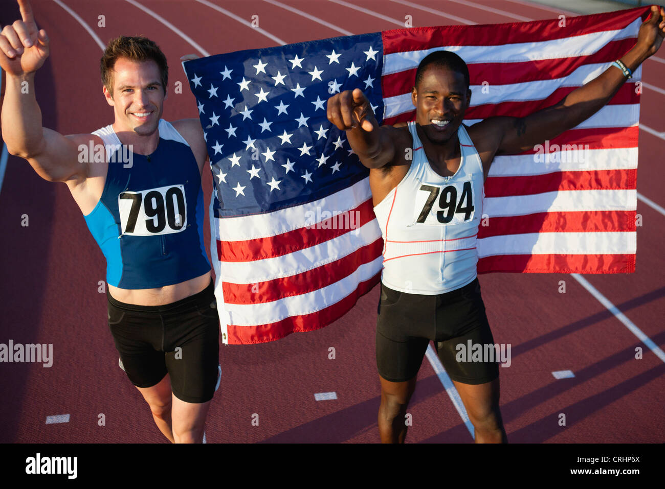Running teammates embracing after race Stock Photo - Alamy