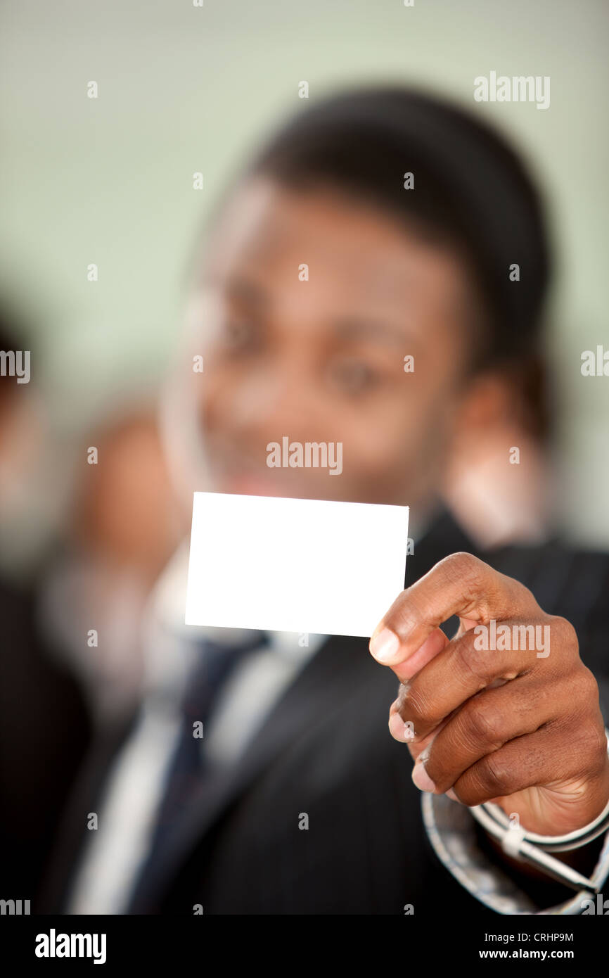 Businessman showing a business card in an office Stock Photo - Alamy
