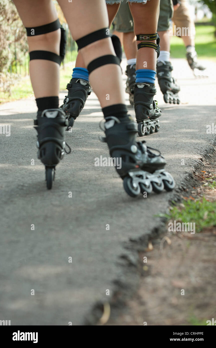 People inline skating in a row, low section Stock Photo - Alamy