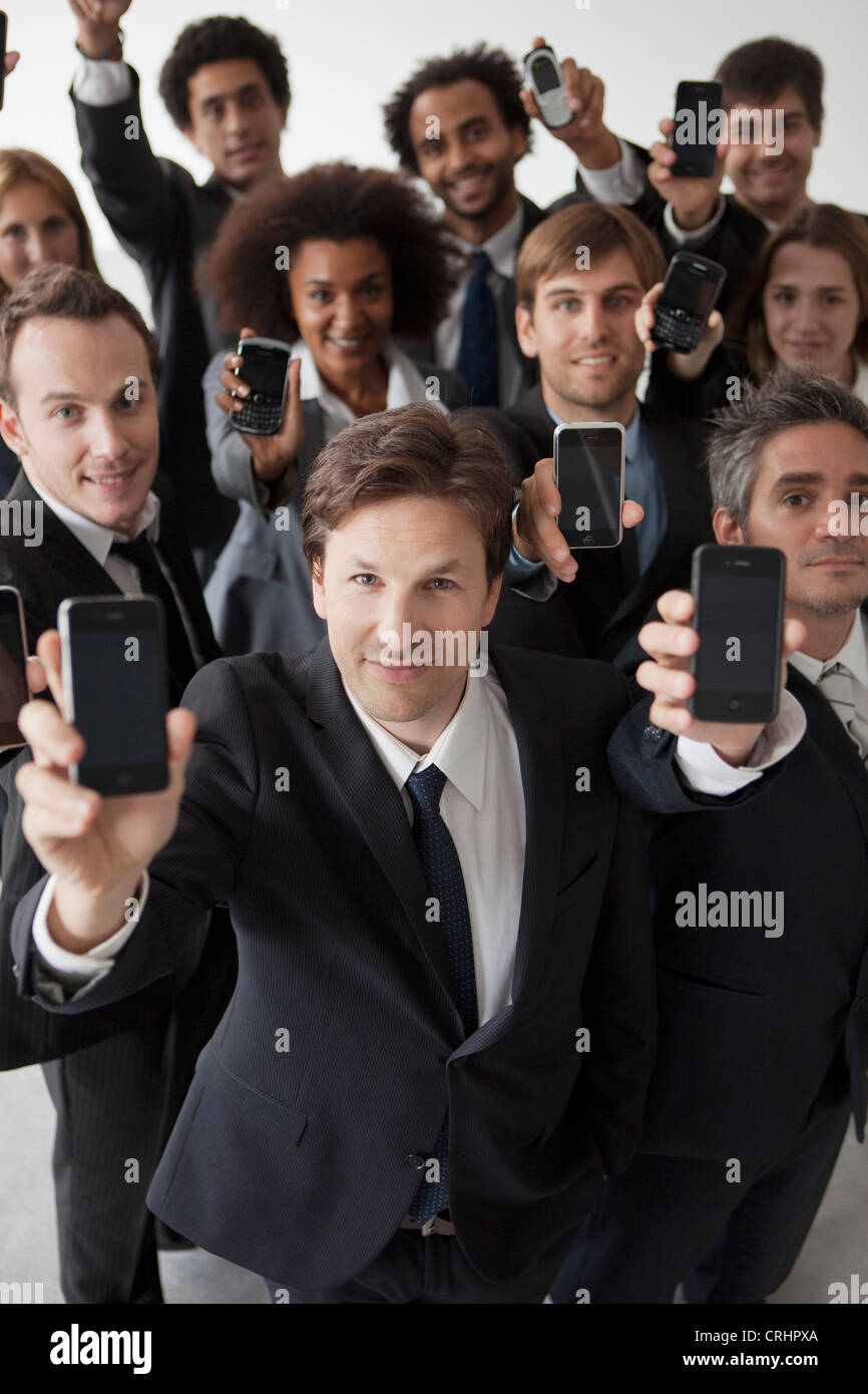 Group people holding phones up adults hi-res stock photography and ...