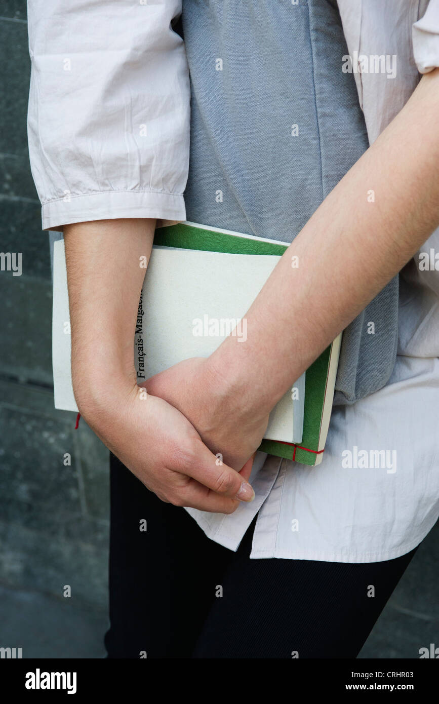 Female student carrying books, cropped Stock Photo - Alamy