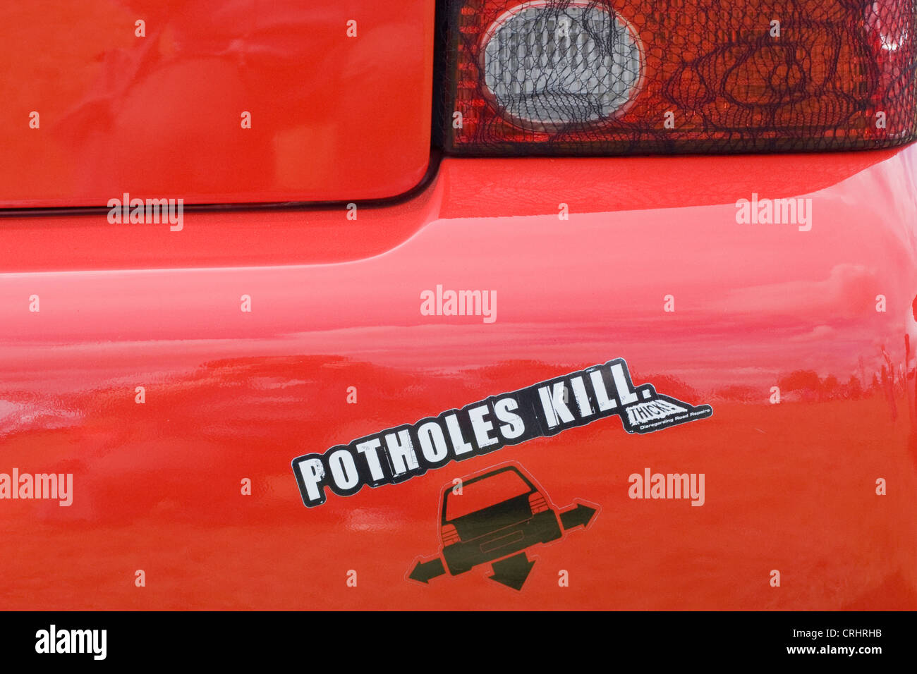 Car with a sicker saying "Pot hole Kill Stock Photo - Alamy