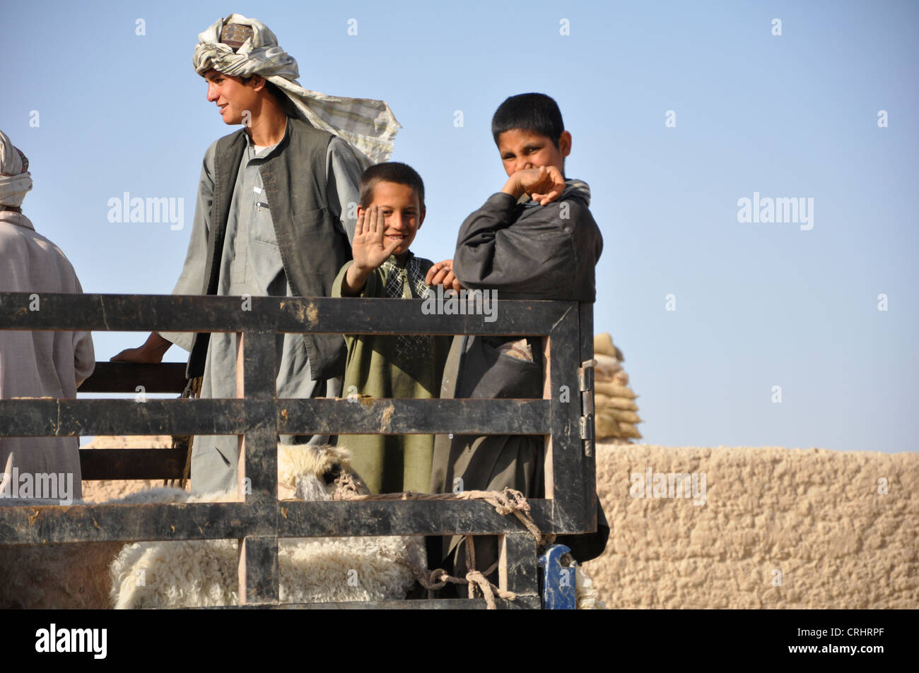 A child shows the palm of his hands at a vehicle checkpoint ...