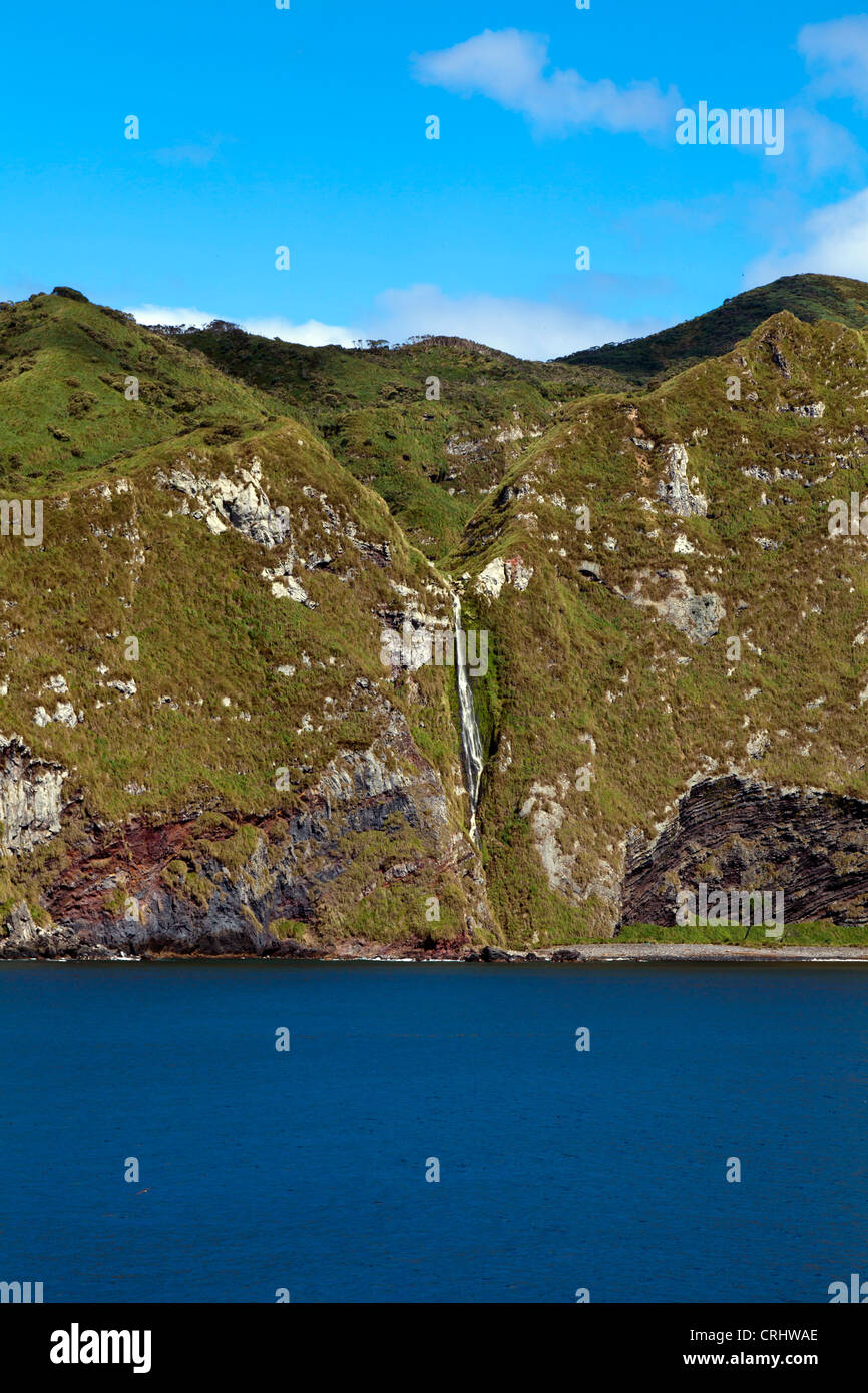 Waterfall and narrow rocky beach on Inaccessible Island, South Atlantic ...