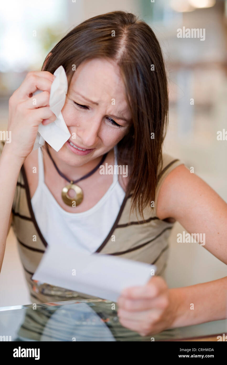 crying, young woman with picture in hand Stock Photo - Alamy