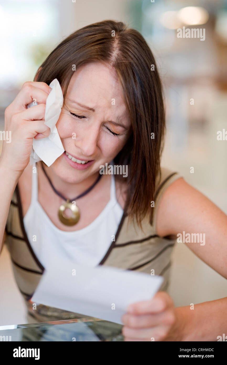 crying, young woman with picture in hand Stock Photo - Alamy