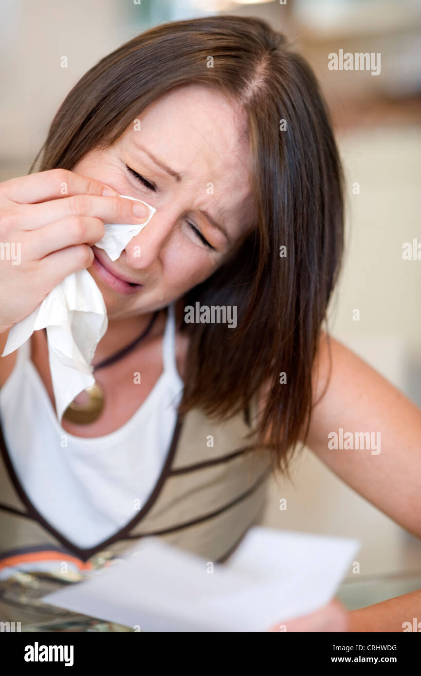 crying, young woman with picture in hand Stock Photo - Alamy