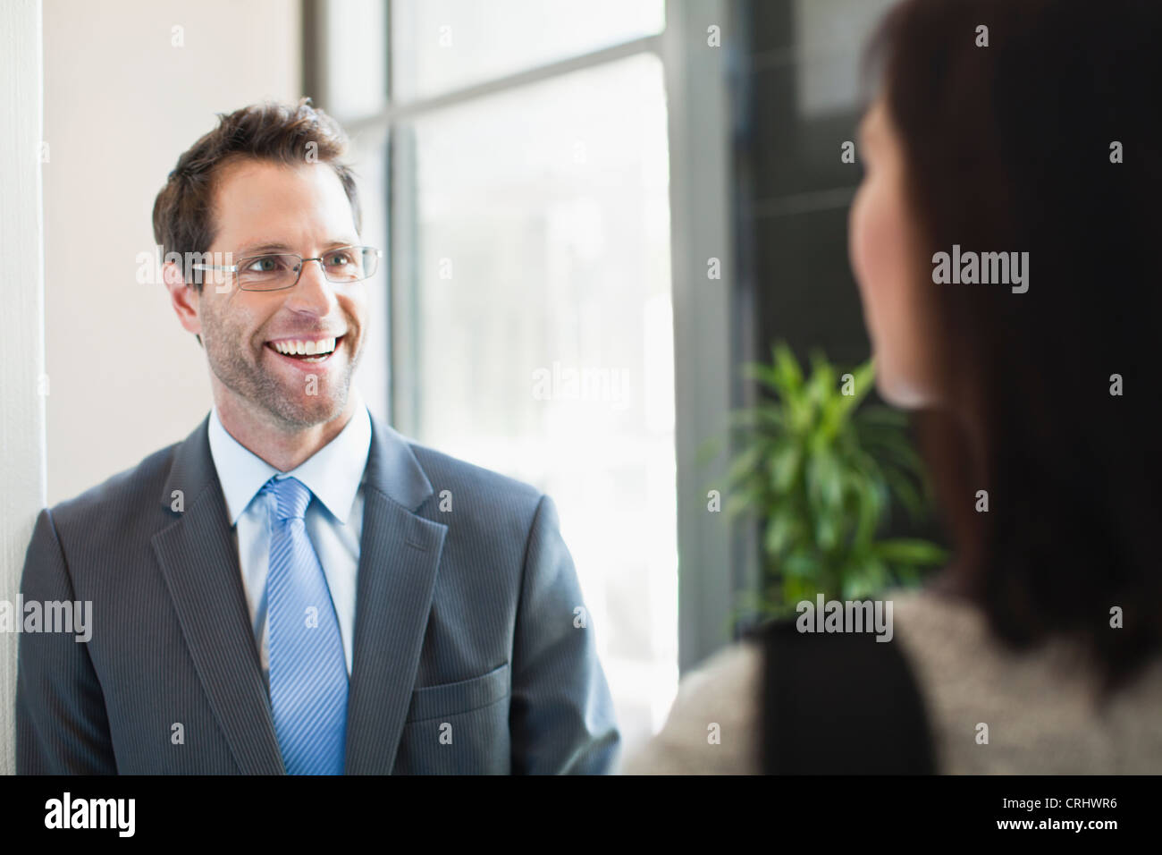 Businessman talking to colleague Stock Photo - Alamy
