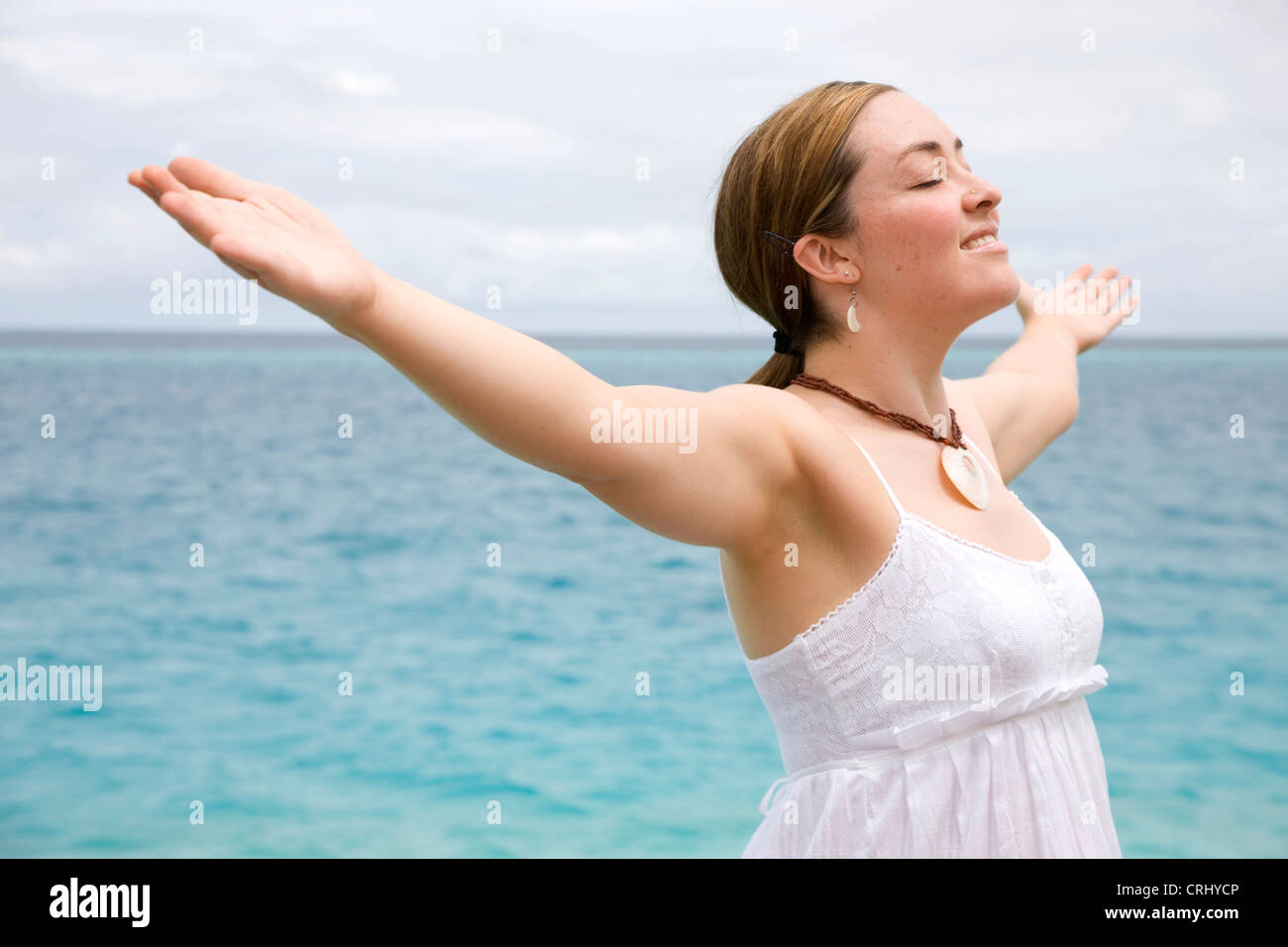 young woman standing at the sea, with outstretched arms Stock Photo - Alamy