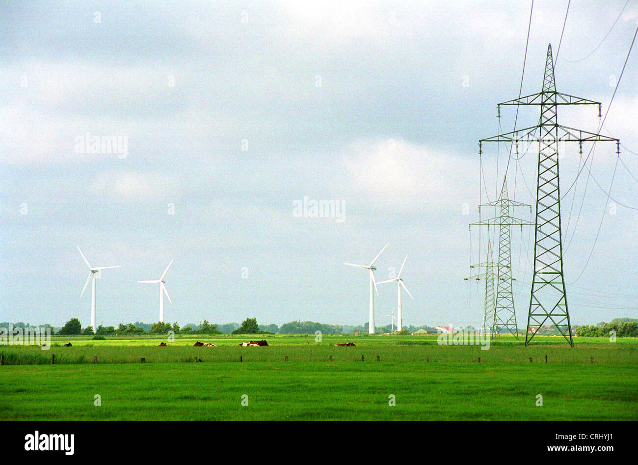 Wind wheels alongside power lines Stock Photo - Alamy