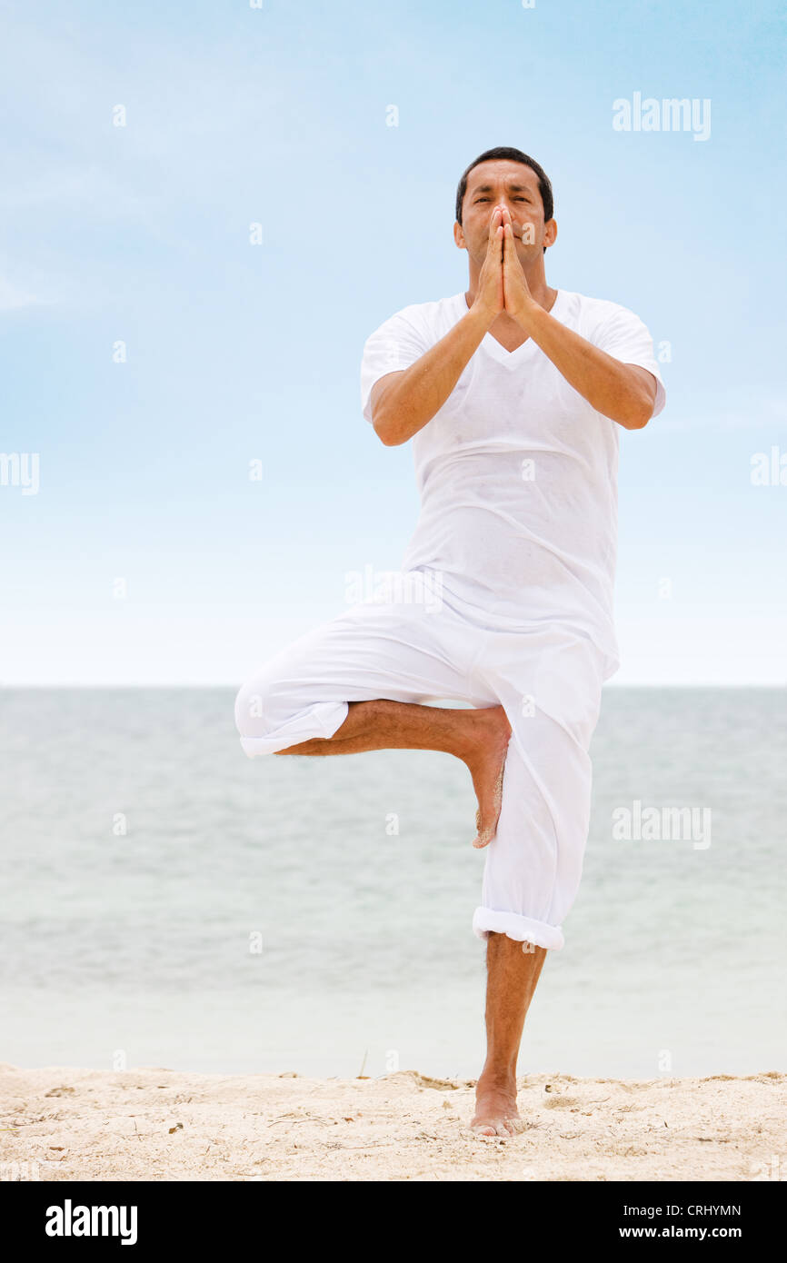 man doing yoga exercises at the beach Stock Photo - Alamy