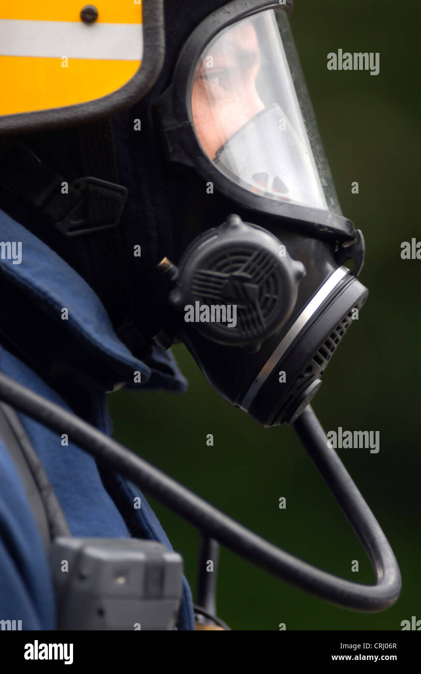 Firefighter wearing face mask breathing apparatus Stock Photo - Alamy