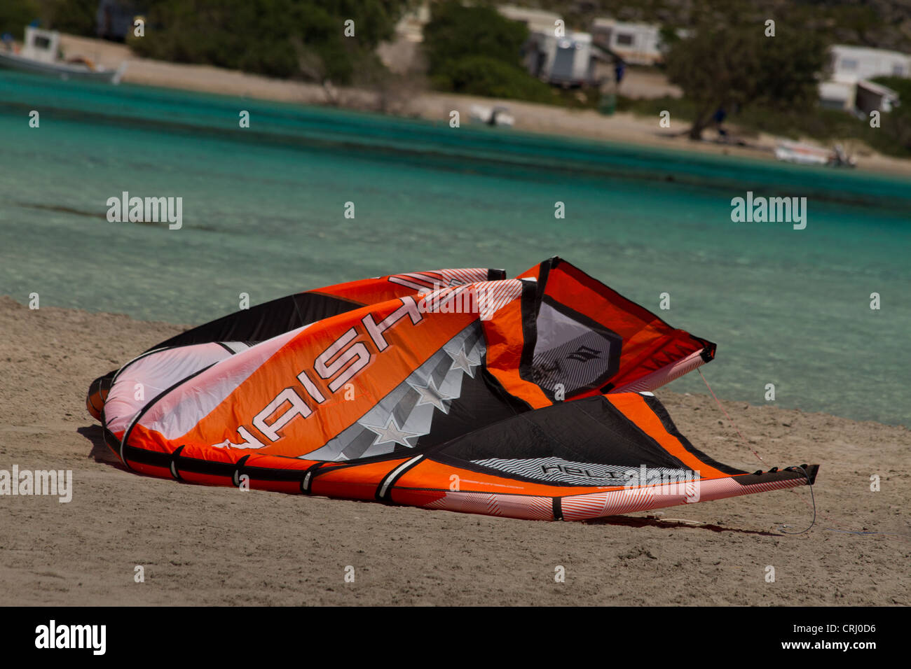 Kite for kite-surfing lying on sand with turquoise sea Elafonissi beach ...