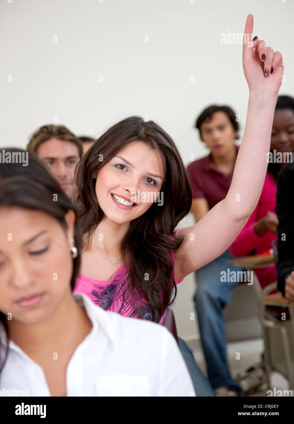 Schoolgirl putting up her hand hi-res stock photography and images - Alamy