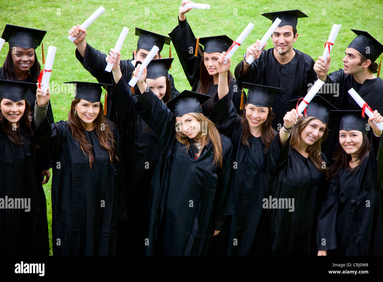 large group of happy graduates with gown, mortarboard and diploma Stock ...