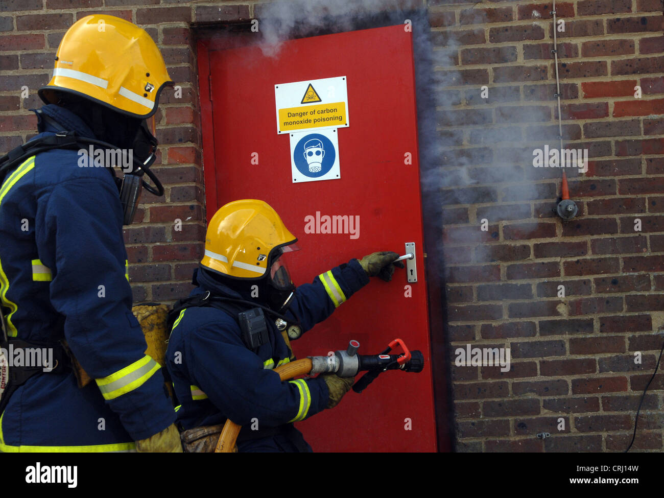 fire fighters opening a door to put out the fire Stock Photo - Alamy