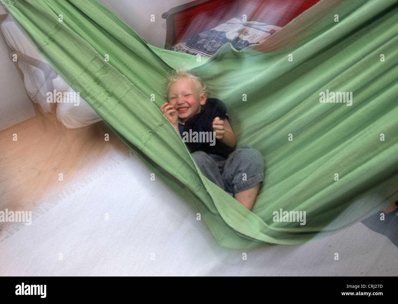 Rocking boy in a hammock Stock Photo - Alamy