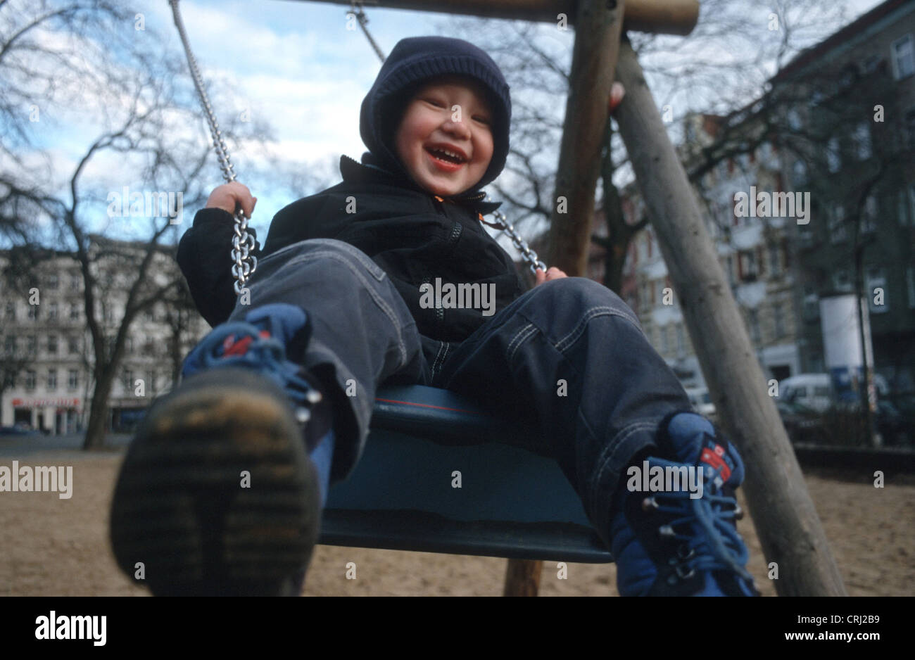 Rocking boy in a playground Stock Photo - Alamy