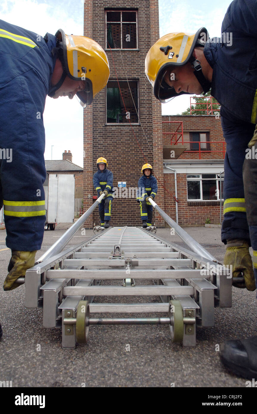 fire fighters putting away a ladder after use Stock Photo - Alamy