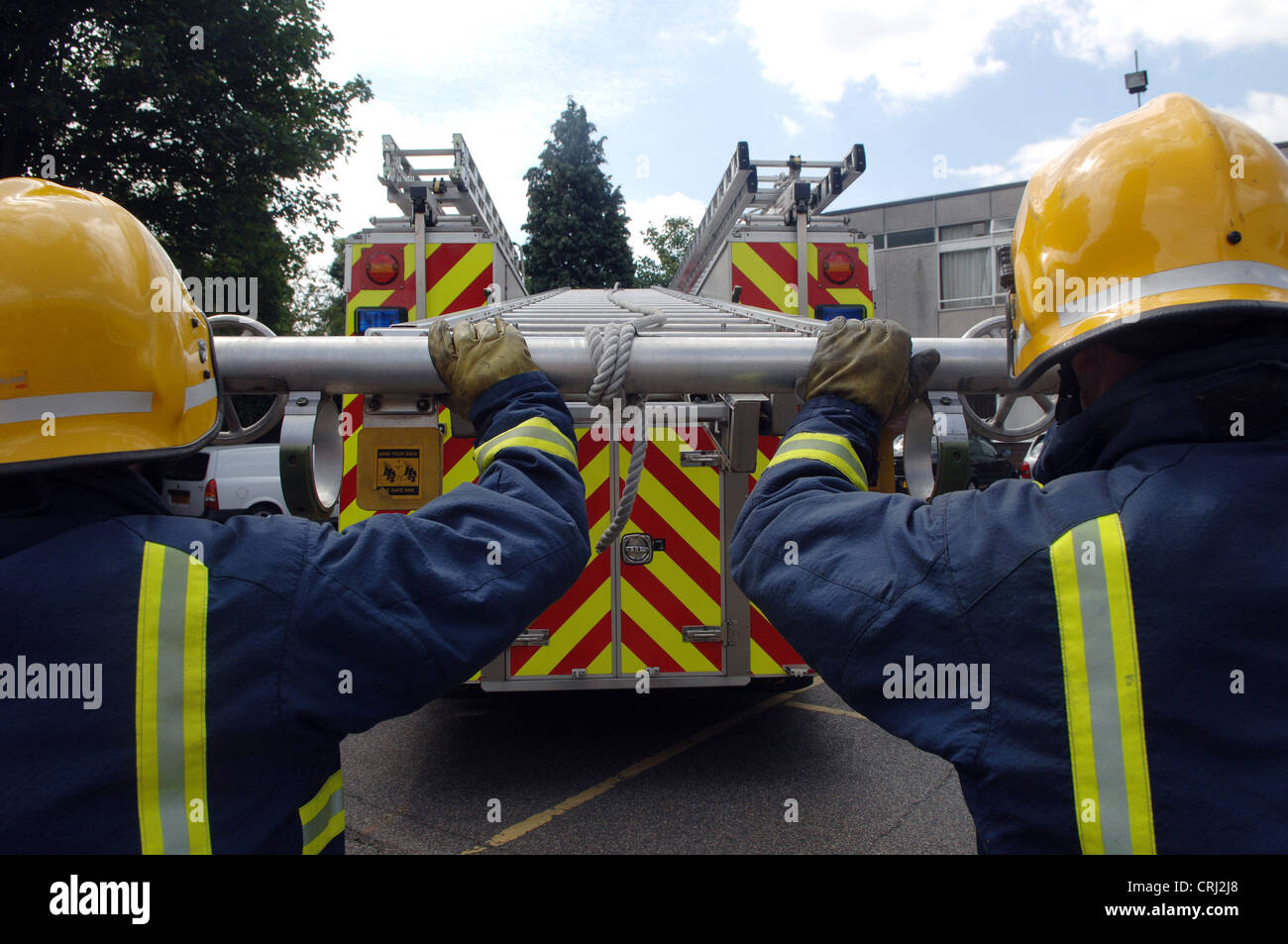 two firefighters pulling the ladder off the fire truck Stock Photo - Alamy