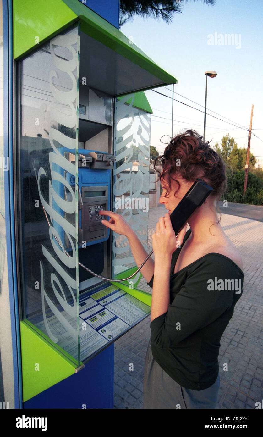 Woman in phone booth Telefonica Stock Photo - Alamy