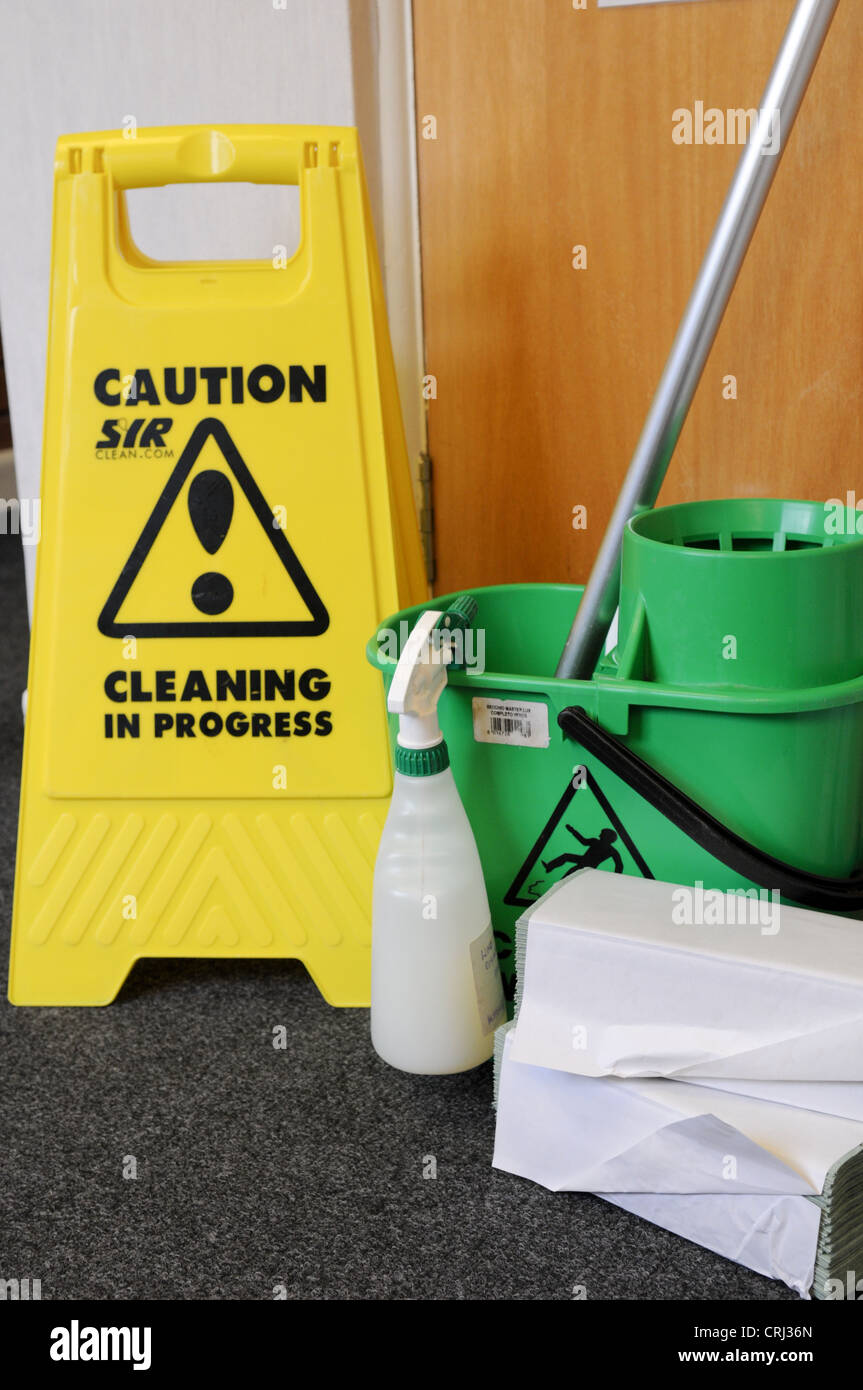 Office cleaning equipment with a yellow caution cleaning in progress ...