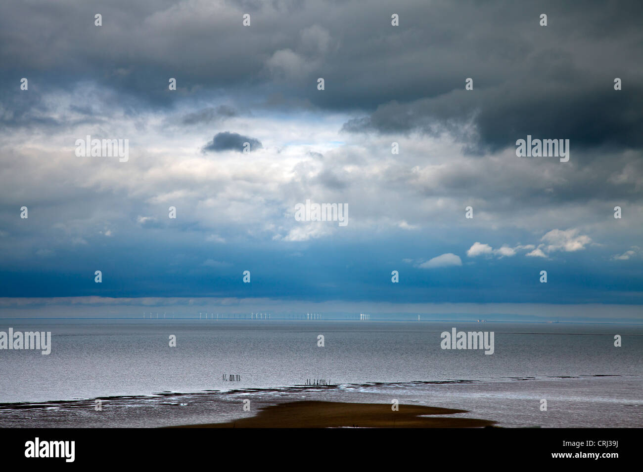 Wind turbines under stormy sky Stock Photo - Alamy