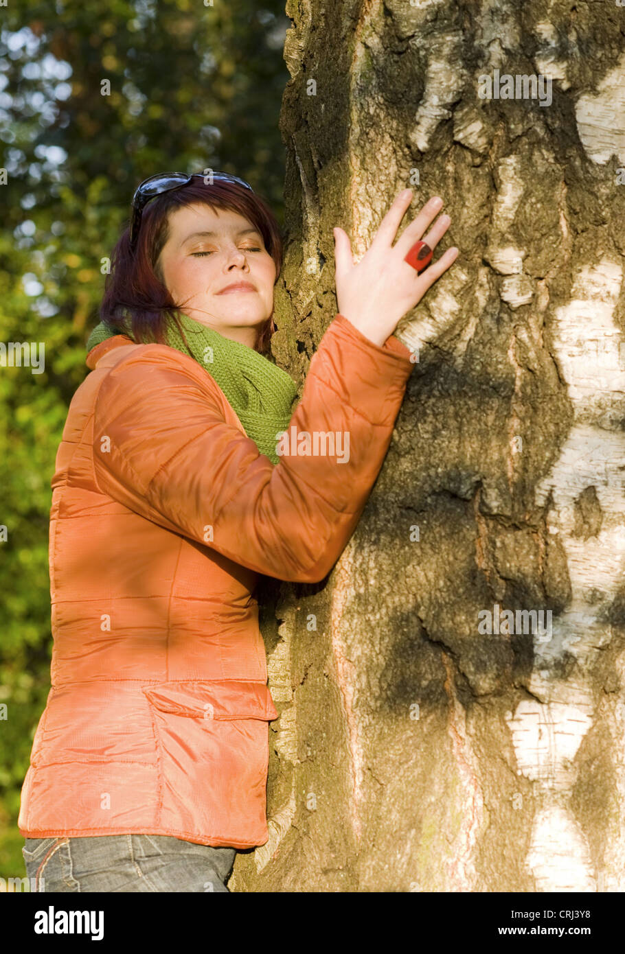 woman in autumn relaxing embracing a tree Stock Photo - Alamy