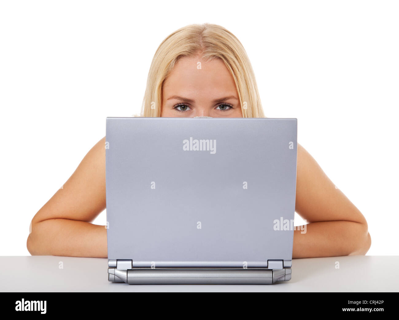 Attractive young woman hiding behind her laptop. All on white ...
