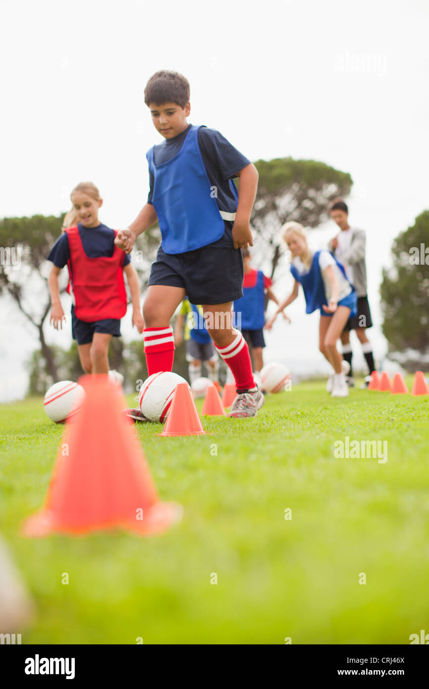 Childrens soccer team training on pitch Stock Photo - Alamy