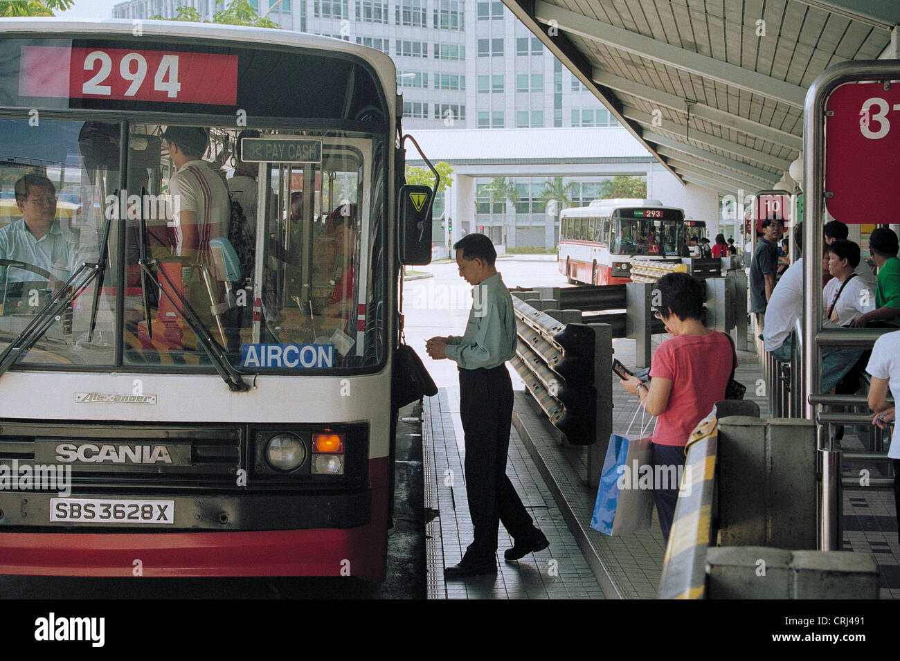 Passengers board a bus at the bus station in Tampines Singapore Stock ...