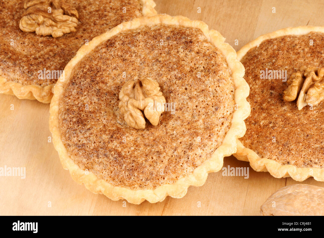 Close-up of some mini walnut tarts over a wooden background Stock Photo ...