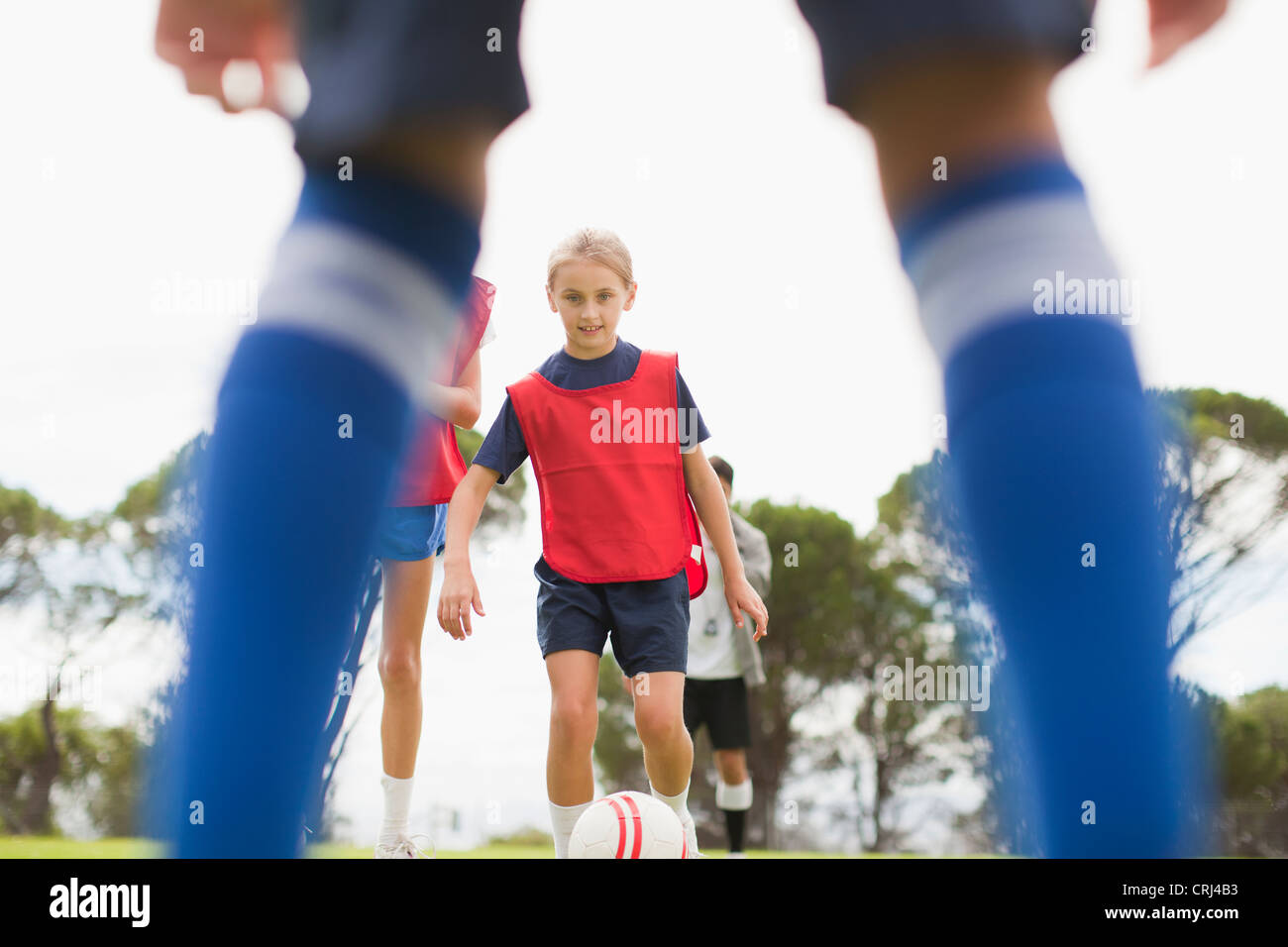Girl playing soccer on pitch Stock Photo - Alamy