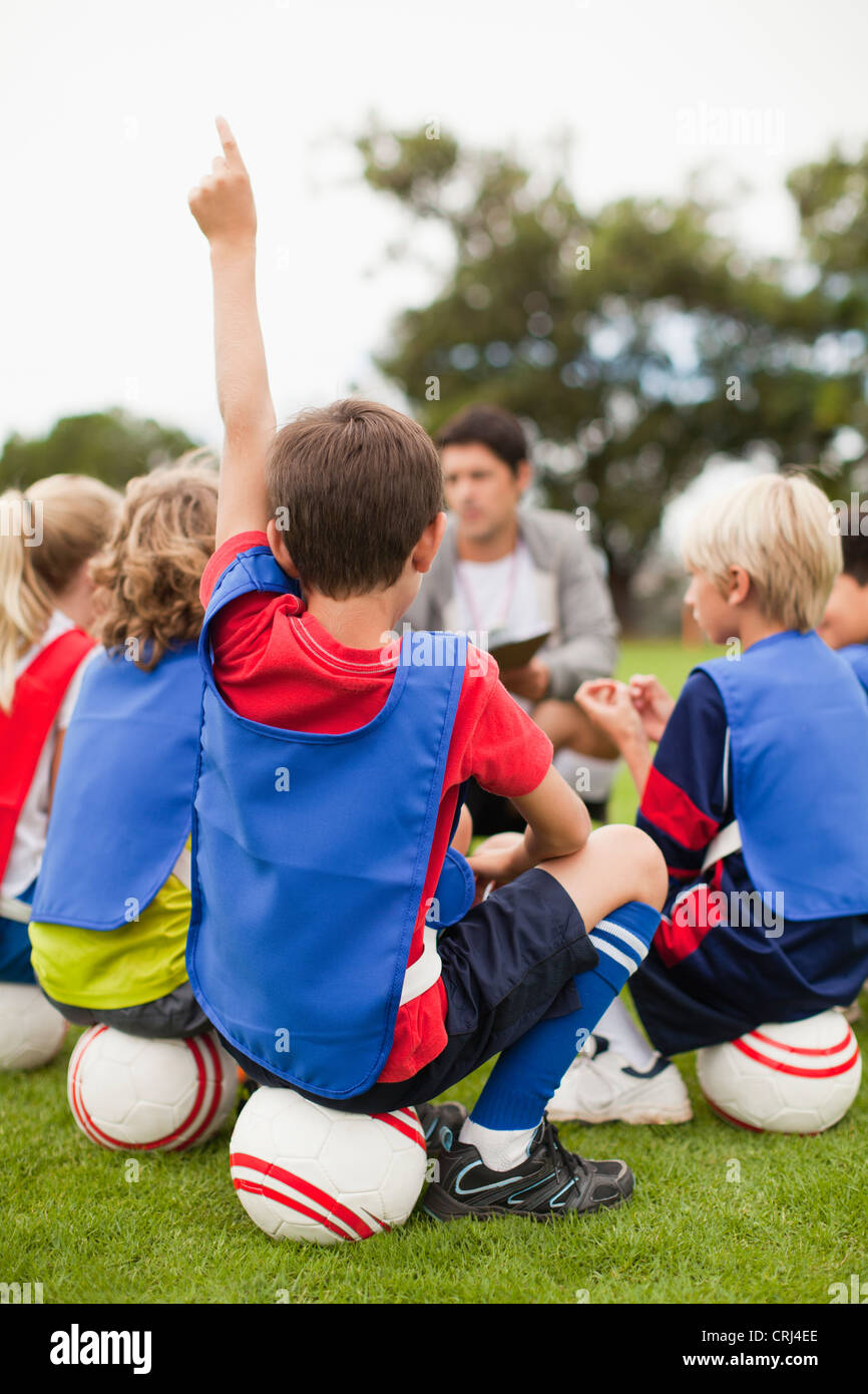 Boy raising his hand during practice Stock Photo - Alamy