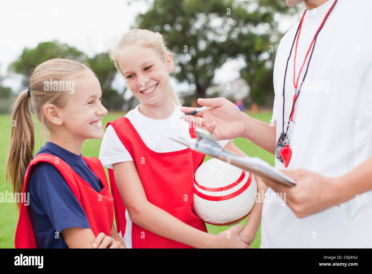 Coach talking to children on soccer team Stock Photo - Alamy